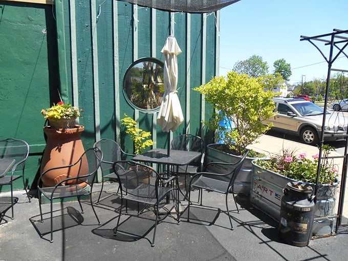 The patio setup proves good things come in small packages—intimate seating surrounded by greenery creates an urban oasis.