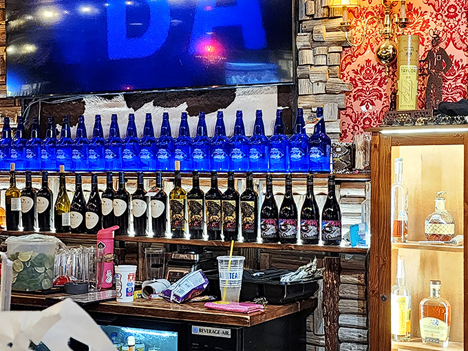 The bar area doesn't just serve drinks—it serves possibilities. Those blue bottles lined up like soldiers are ready for duty in your evening's adventures