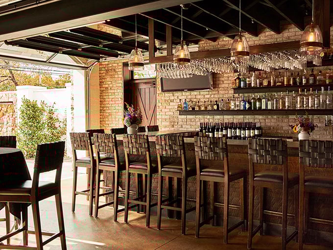 The bar area combines rustic charm with sophisticated service—where strangers become friends over perfectly poured drinks and shared food recommendations.