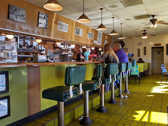 The counter seats—where solo diners become regulars and the staff eventually knows your order before you sit down. 