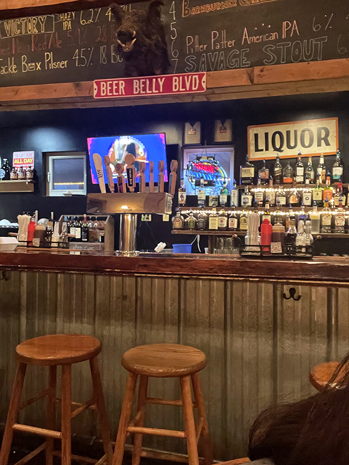 The bar area whispers, "Stay awhile," with its chalkboard beer menu and "Beer Belly Blvd" sign—a roadmap to happiness for the hop-inclined visitor.