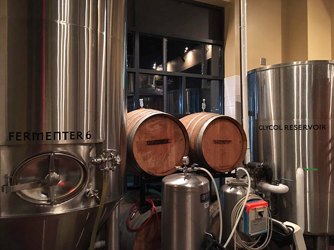 Behind the scenes where the magic happens. These tanks and barrels aren't just equipment—they're the laboratory where liquid happiness is created.