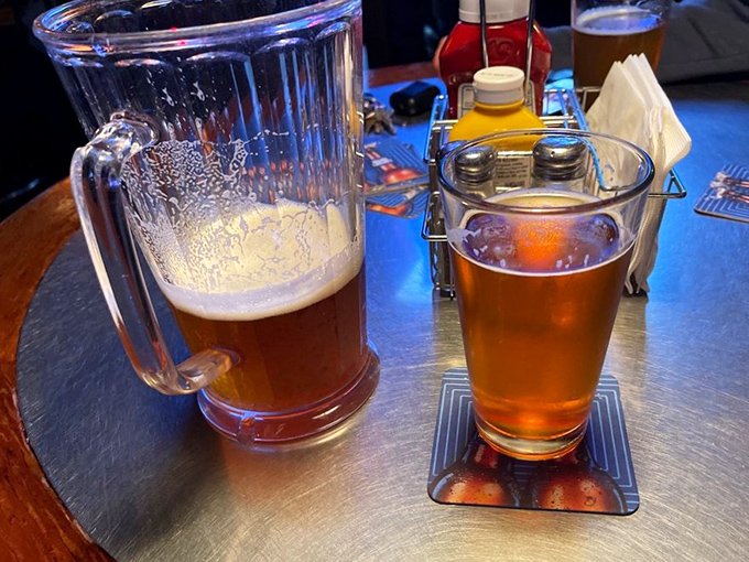 Beer served in proper glassware—a pitcher for sharing and a pint for savoring. The amber glow promises the perfect palate cleanser between bites.