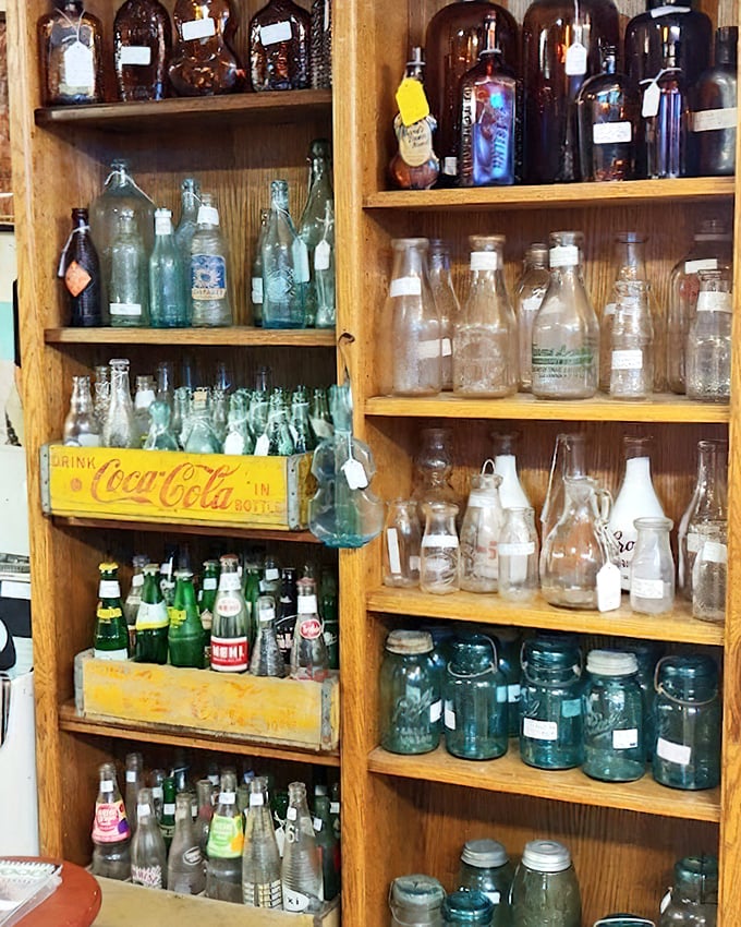 The bottle collector's dream—from cobalt blue medicine bottles to vintage Coca-Cola crates, each glass vessel holds history, not liquid.