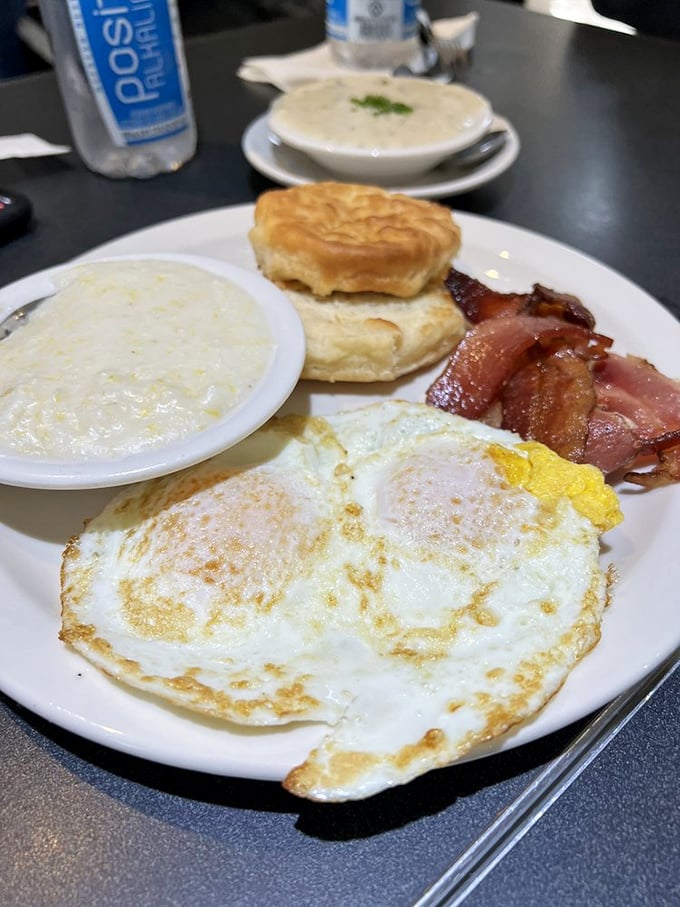 The classic Southern breakfast plate—where eggs, bacon, grits, and biscuits gather for their daily morning meeting of deliciousness.