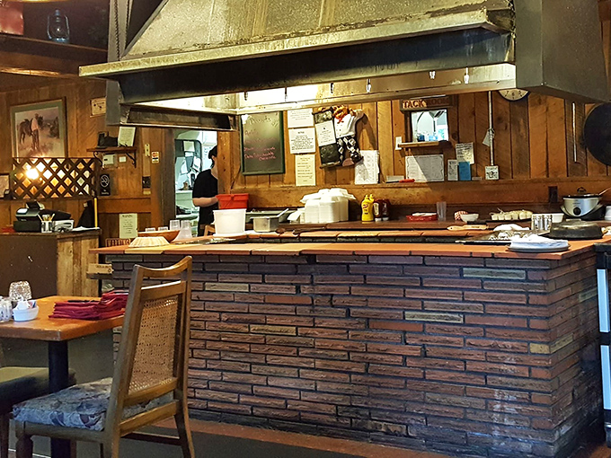 The brick grill station—command central for meat mastery. Some chefs have offices, these folks have fire and iron.