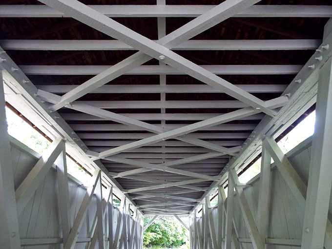 Engineering as art: The geometric precision of these crossbeams has supported travelers for generations while creating accidental masterpieces of light and shadow.