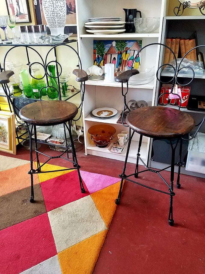 These wrought-iron ice cream parlor chairs aren't just seating—they're time machines to an era when conversation was the only thing on the menu.