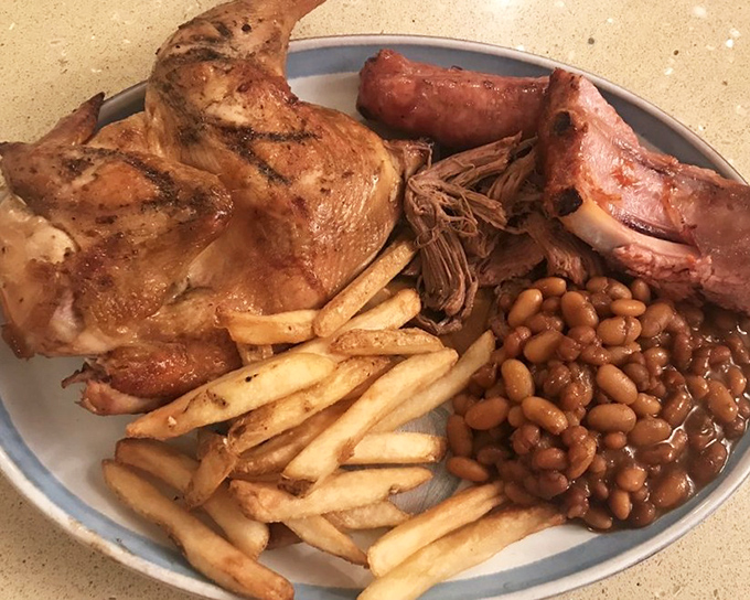 A plate that doesn't know the meaning of restraint. Chicken, ribs, beans, and fries—this isn't a meal, it's a declaration that today is special.
