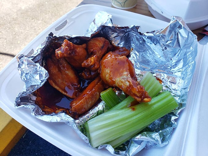 Wings nestled in foil like precious cargo, with celery standing guard. A buffalo-sauced treasure worth every sticky finger.