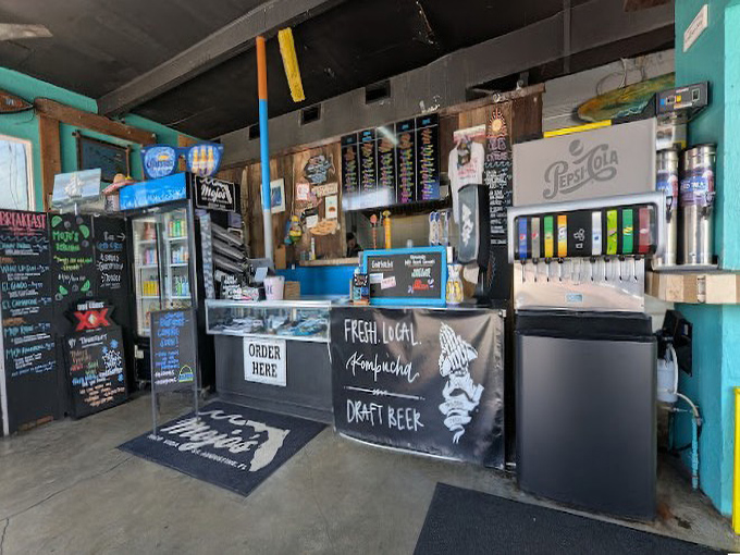 Where taco magic happens—the ordering counter promises "Fresh Local Kombucha" alongside your Mexican-inspired feast.