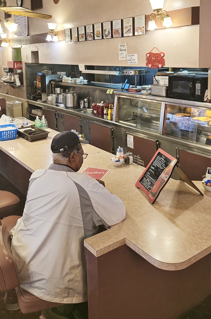 The counter – where solo diners find community, regulars get their usual without asking, and coffee cups mysteriously refill themselves.