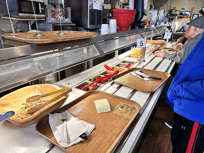 The cafeteria line – where decisions are made, anticipation builds, and you can almost hear your arteries protesting (but your taste buds cheering).