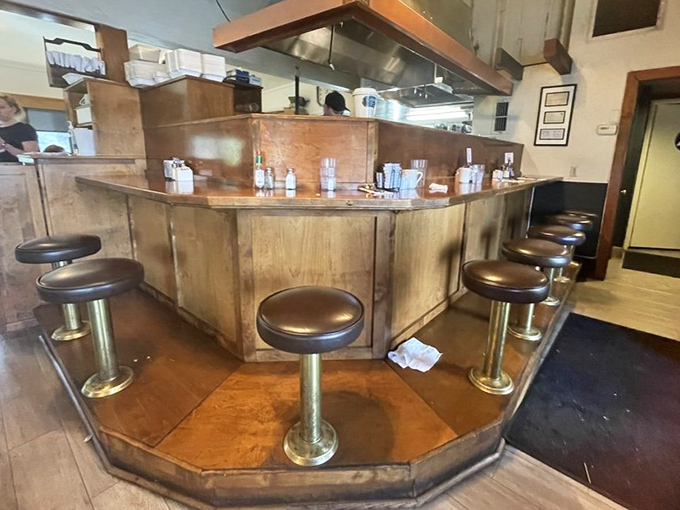 The counter seats—where solo diners become regulars and the breakfast show unfolds before your eyes. Prime real estate for French toast enthusiasts.