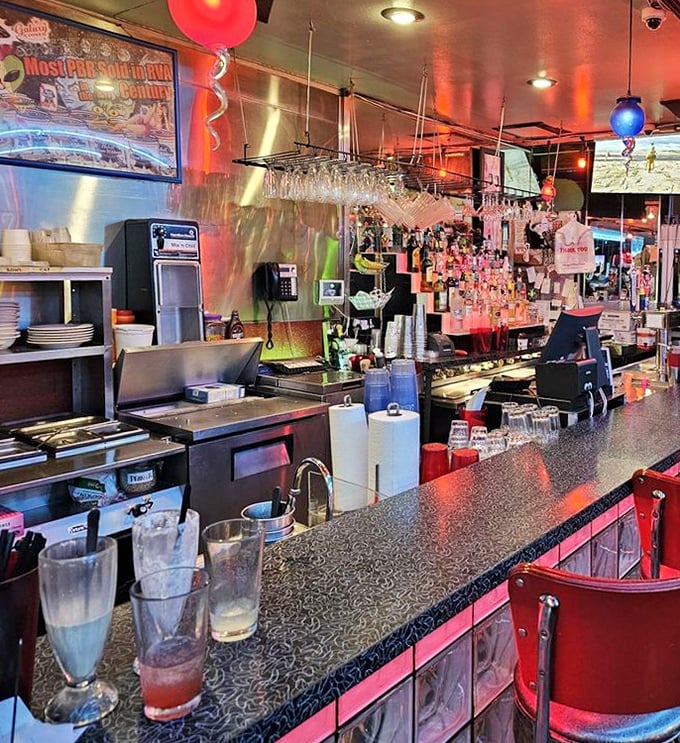 The counter where magic happens—milkshakes mixed, orders called, and conversations flow as freely as the coffee. Diner perfection in action.