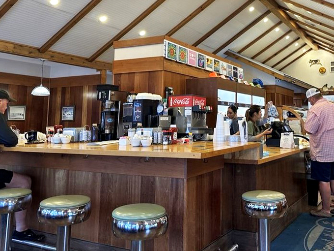 The counter where magic happens—classic diner seating with a view of the action. Those chrome stools have supported generations of hungry patrons.