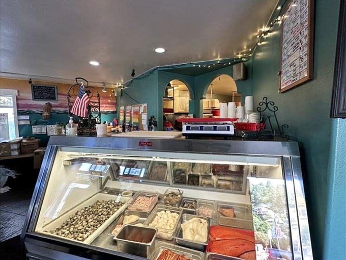 Behind the counter, where ocean meets plate. The display case showcases the day's fresh catch, ready for its culinary transformation.
