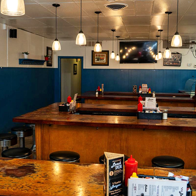 Blue wainscoting meets worn wooden counters in a color scheme that says "we've been here awhile and plan to stay." Comfort in consistency.