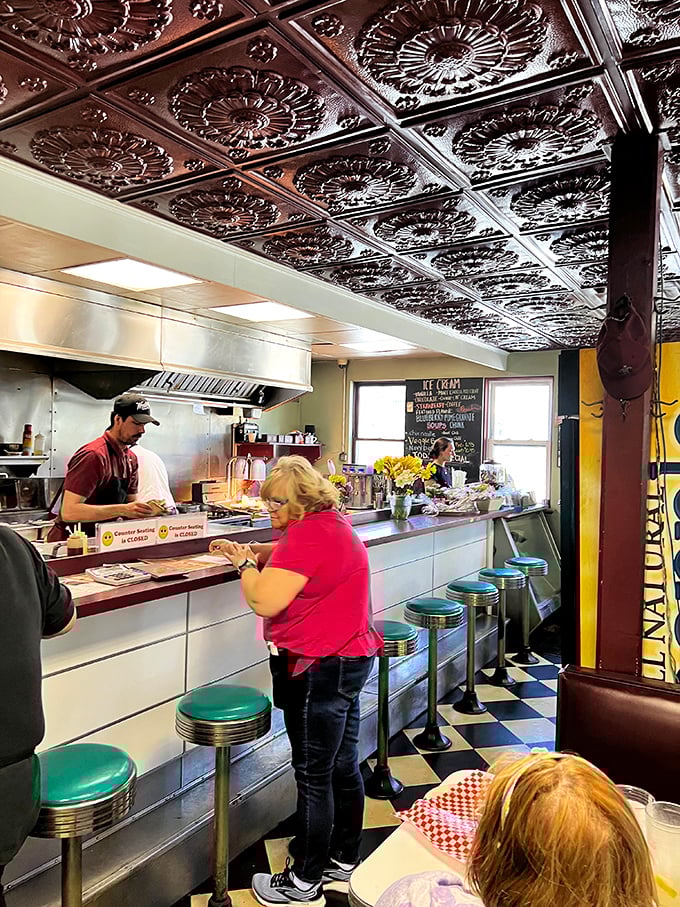 The counter space – where solo diners find community, coffee flows freely, and the ceiling tiles above have witnessed countless "I'll just have one more bite" moments.