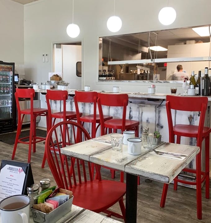Those red chairs aren't just seating—they're front-row tickets to the best breakfast show in town, with white-washed tables setting the stage.