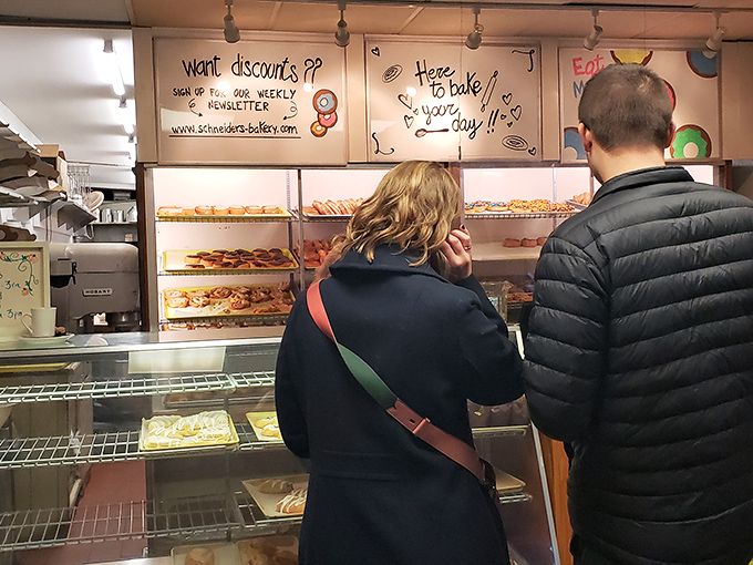 The universal language of anticipation. These customers know good things come to those who wait—especially when those good things are freshly made donuts.