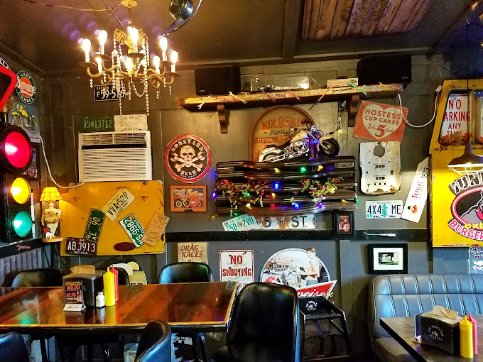 Wall decor that tells a thousand stories. Each license plate and traffic light has witnessed countless food-induced happy faces.