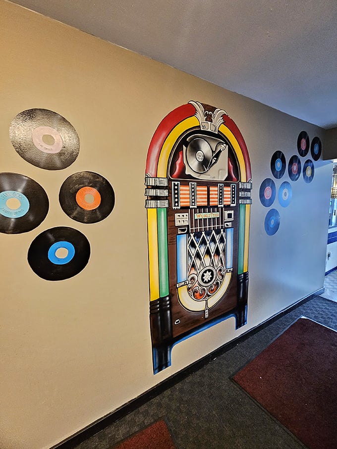 The wall of vinyl records and jukebox mural isn't just decoration—it's a time machine to when music came with your meatloaf.