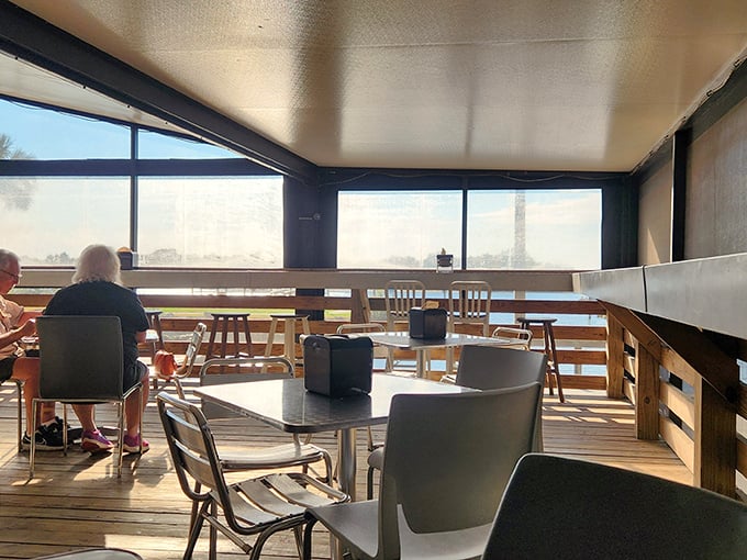 The screened porch seating area—where the only thing competing with the barbecue is the view, and it's a delicious draw.