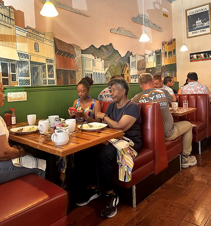 Red vinyl booths cradle diners as they dive into plates of morning deliciousness, beneath the watchful gaze of Calistoga's painted historic skyline.