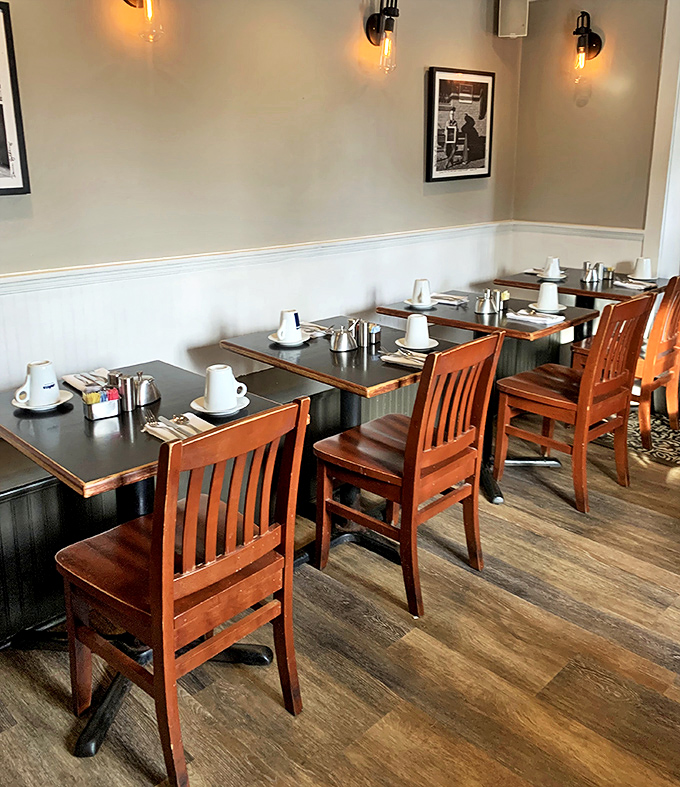 Tables set with anticipation—wooden chairs and simple settings that let the food be the star of this breakfast show.
