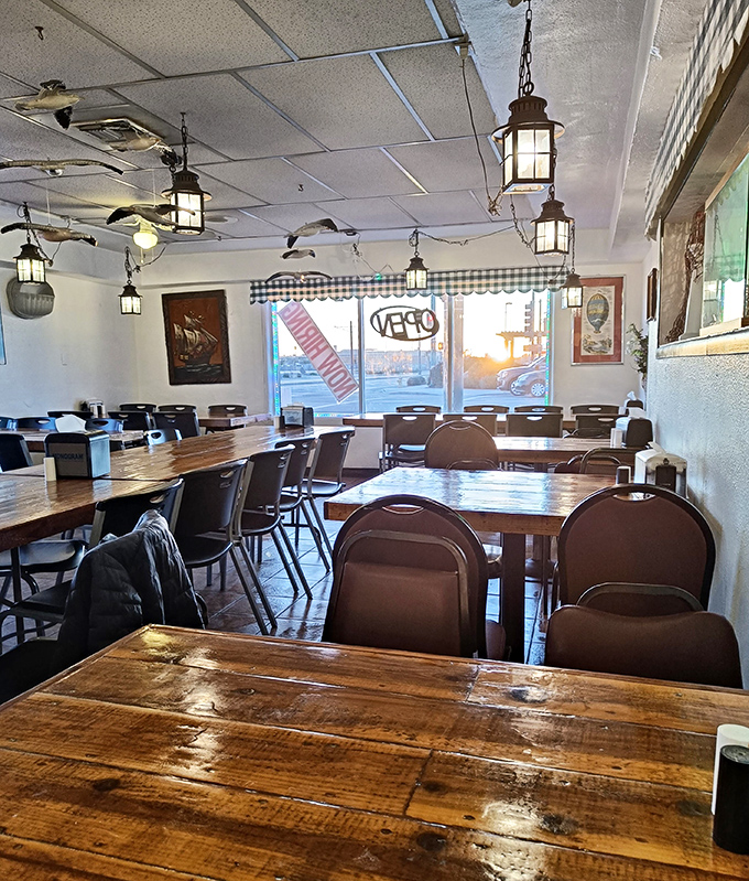 Rustic wooden tables bathed in natural light, with hanging lanterns that could guide ships to shore. Casual comfort that invites you to linger over one more hush puppy.