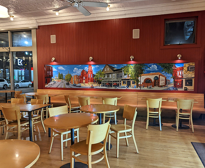 The dining area balances warmth and simplicity, with a colorful mural celebrating Little Italy—the perfect backdrop for your impending sugar rush.