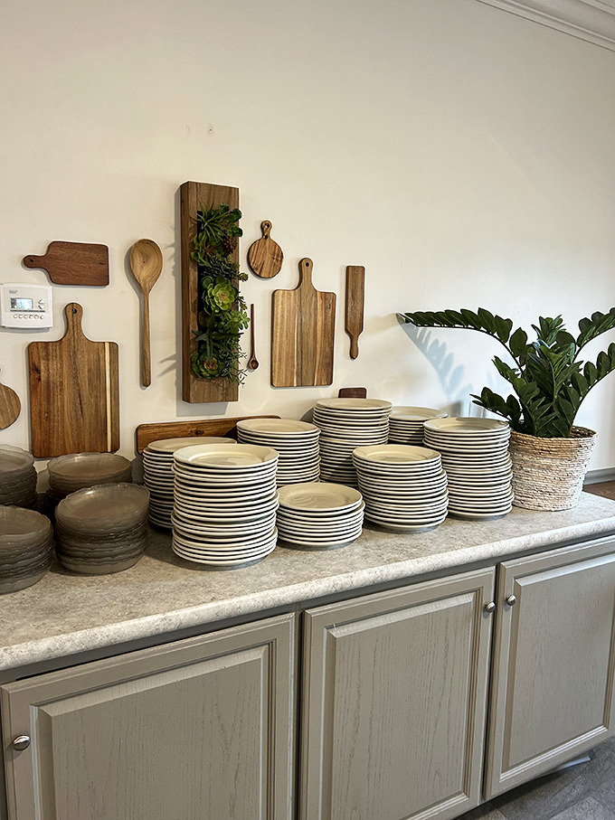 Stacks of simple white plates await their moment of glory—soon to be the canvas for comfort food masterpieces.