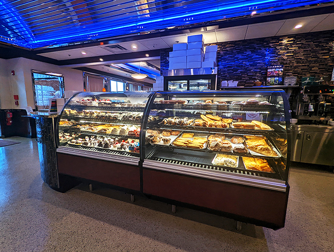 That dessert case isn't displaying pastries—it's showcasing edible works of art. Each shelf offers a different path to sweet satisfaction. 