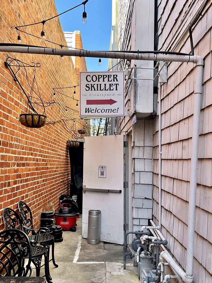 The unassuming side entrance sign points the way like a culinary treasure map, complete with string lights to guide hungry explorers.