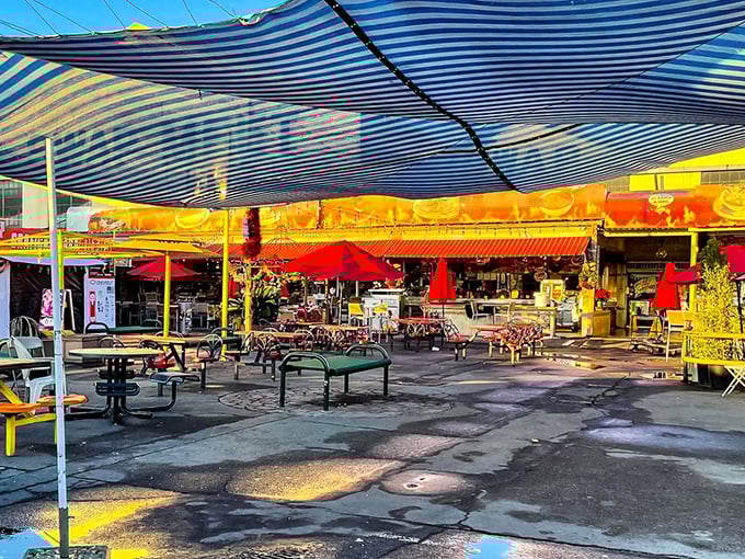 A kaleidoscope of colors and textures under striped canopies, where plastic tables become five-star dining with the right food.