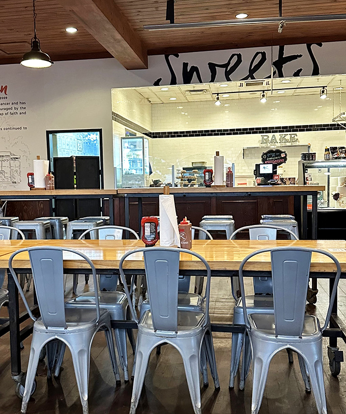 Metal chairs, wooden tables, and a glimpse of the Sweet Shop in the background – where you'll head after convincing yourself you deserve dessert.