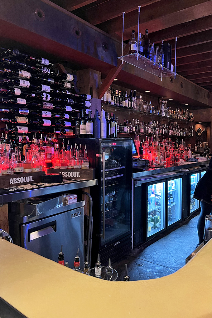 Vintage signs and American flags create a speakeasy vibe. This isn't just decoration—it's a time machine to when barns housed horses, not filet mignon.
