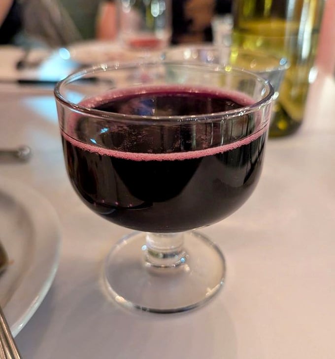 That deep ruby Lambrusco isn't just wine—it's the perfect pizza companion, cutting through richness with fruity acidity in a delightful liquid high-five.