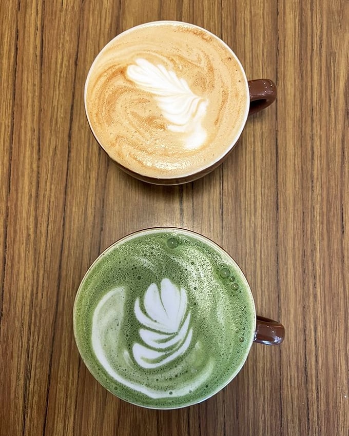 Latte art that belongs in a gallery. The matcha version below isn't just a drink—it's a statement piece in a cup.