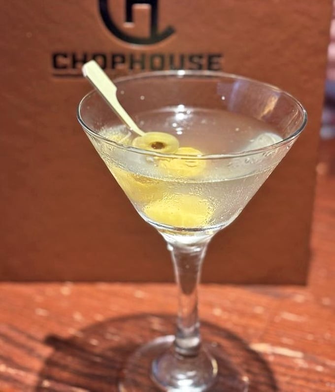 A martini so pristine it makes James Bond look sloppy. That olive isn't just garnish—it's punctuation on a liquid sentence.