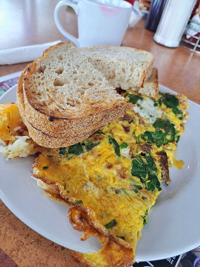 An omelet that's clearly been to college—educated with spinach and cheese while maintaining its down-to-earth potato sidekick.
