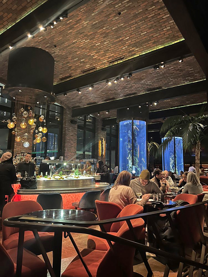 Those cylindrical aquariums aren't just decoration—they're a reminder that your dinner had neighbors before becoming the catch of the day.