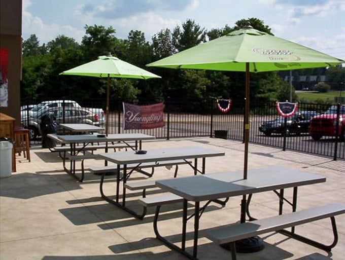 Outdoor dining with shade umbrellas standing guard against the Ohio sun – al fresco without the sunburn.