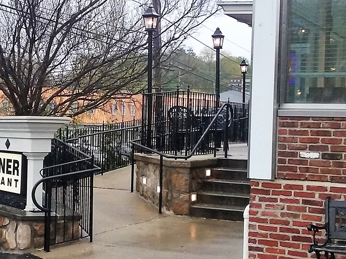 The entrance beckons with stone steps and wrought iron railings—a pathway to comfort that thousands have happily traveled.