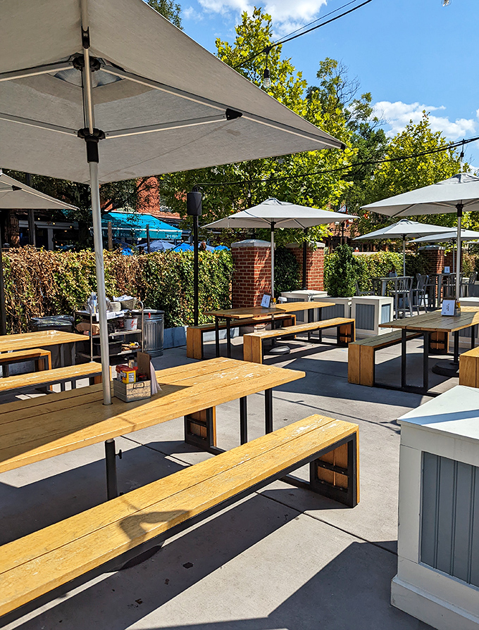 Al fresco dining that captures Baltimore's charm—simple wooden tables where summer breezes complement every bite and sip.
