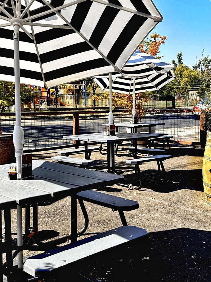 The outdoor seating area offers a sun-dappled escape under striped umbrellas—perfect for people-watching while you contemplate a second helping.
