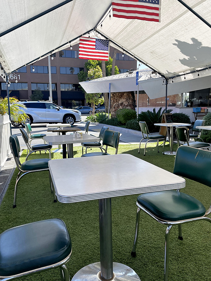 Outdoor dining with Americana flair—where artificial turf meets metal tables under American flags. It's patriotism you can eat with.