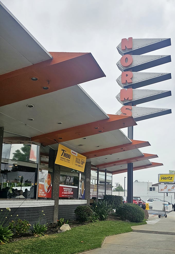 The distinctive Googie architecture stands out against the California sky—mid-century modern design that's aged better than most Hollywood stars.