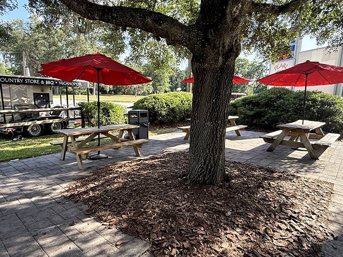 Al fresco dining, Florida-style. Red umbrellas provide shade while you contemplate ordering seconds under the watchful eye of ancient oak trees.